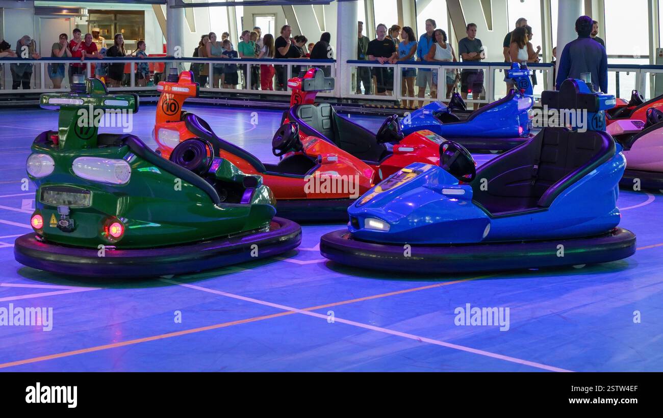 People having fun and bumping into each other with electric bumper cars ...