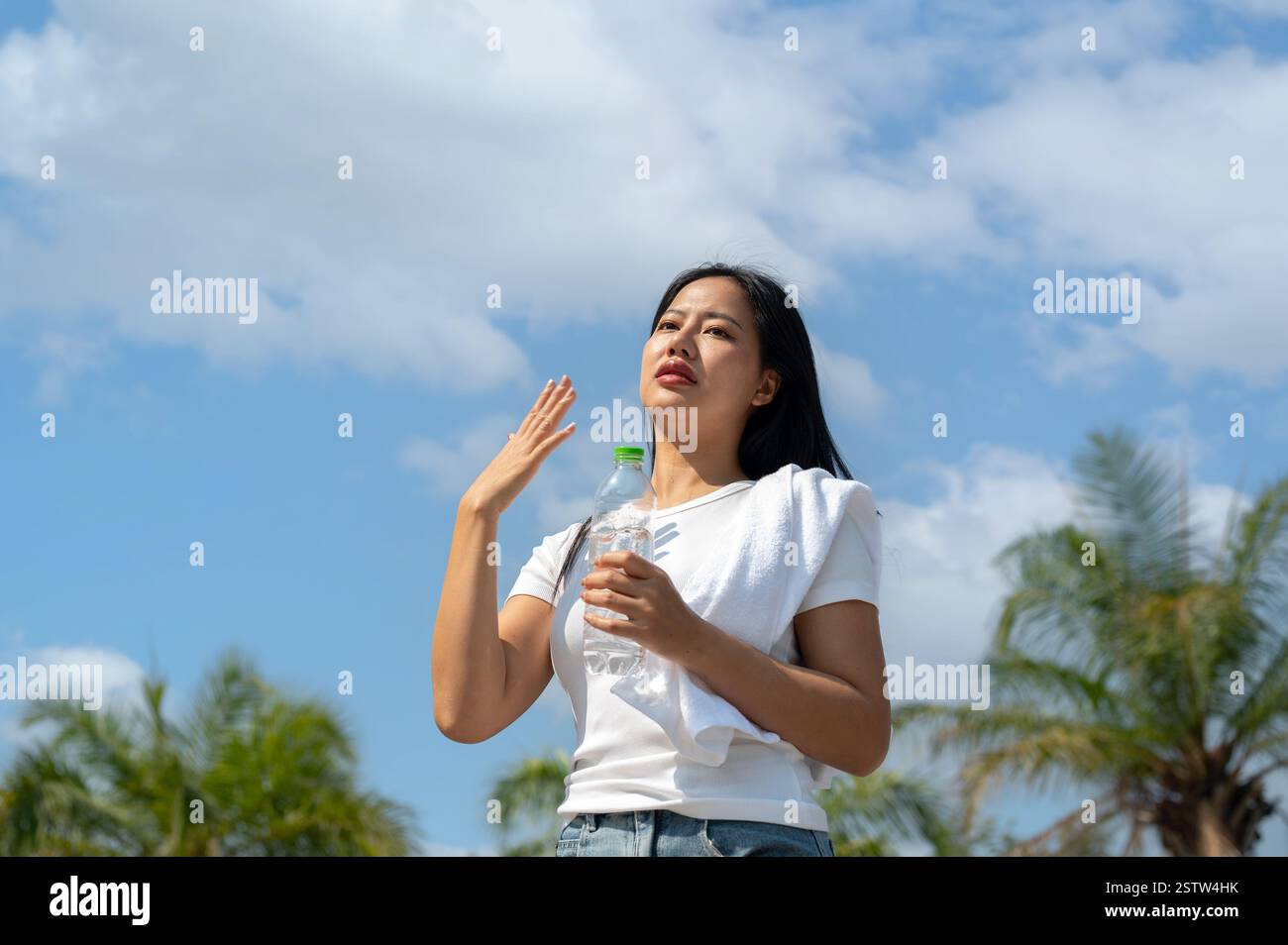 A beautiful women feeling uncomfortable and fanning herself after ...