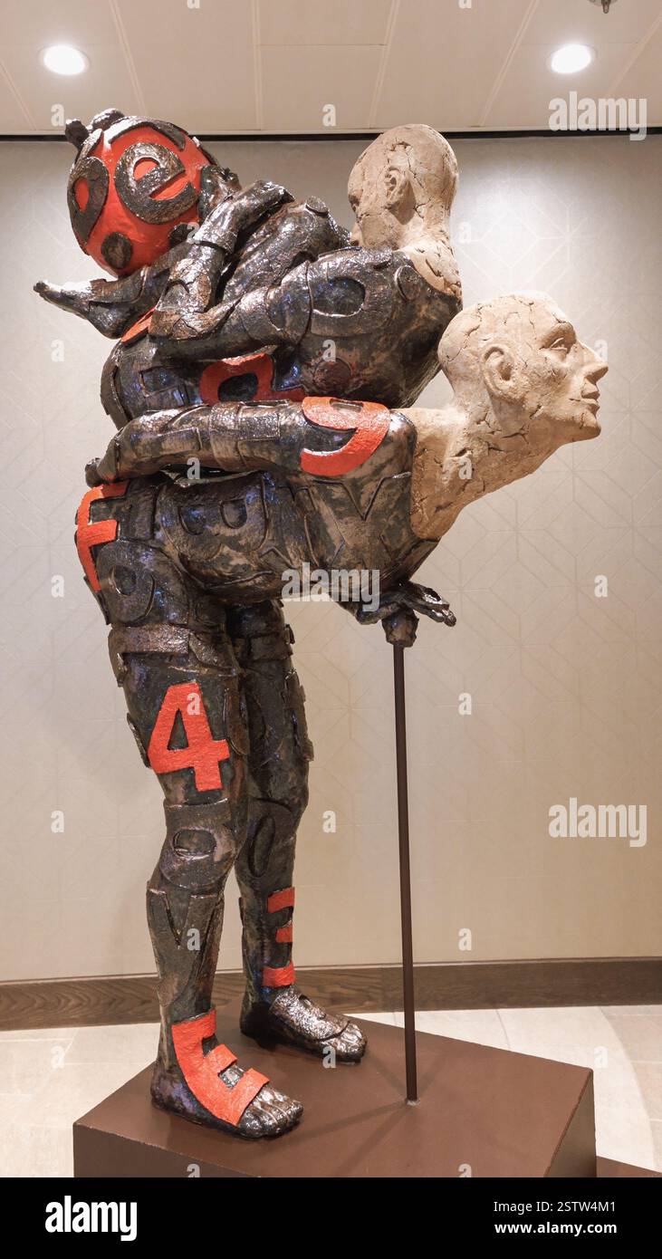 Buff Metallic Humanoid Sculpture with Red Numbers and Globe on Back ...
