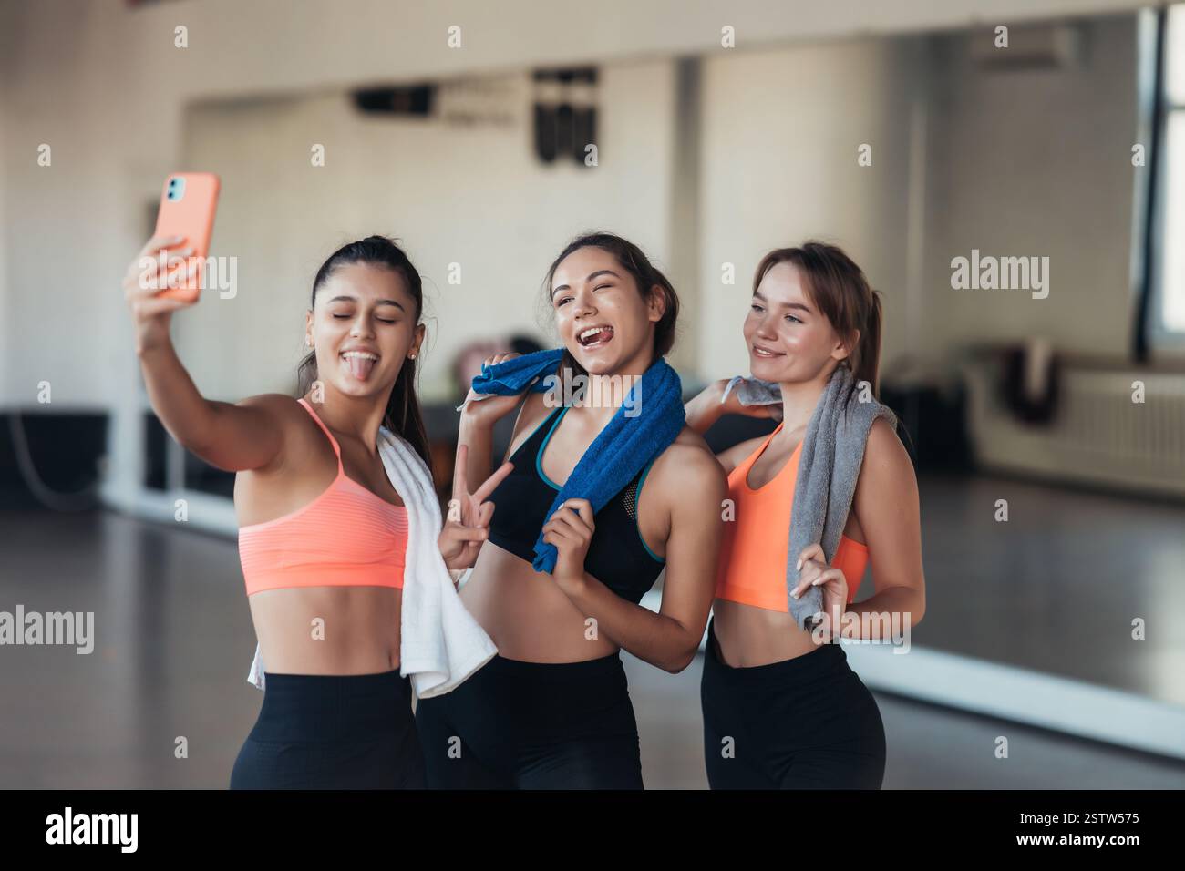Two female friends taking a selfie photo after hard workout Stock Photo ...