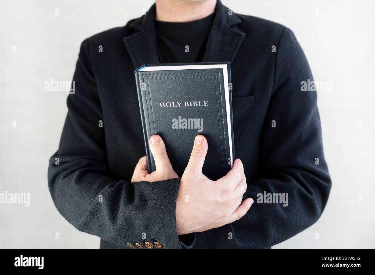 the Holy Bible in men's hands. The concept of faith and religion ...