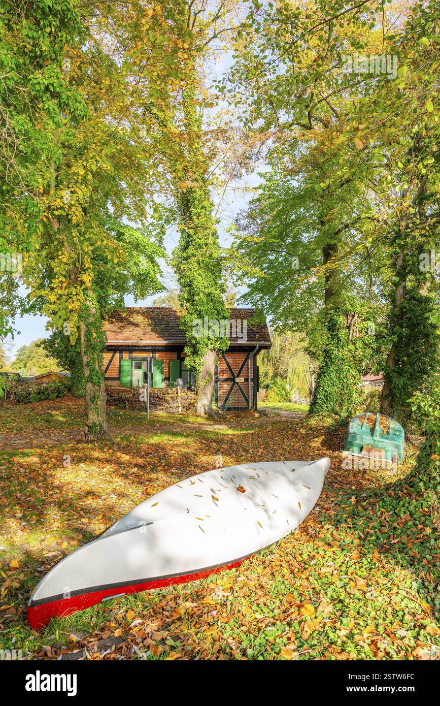 Upside-down kayak and rowing boat in front of a small half-timbered ...