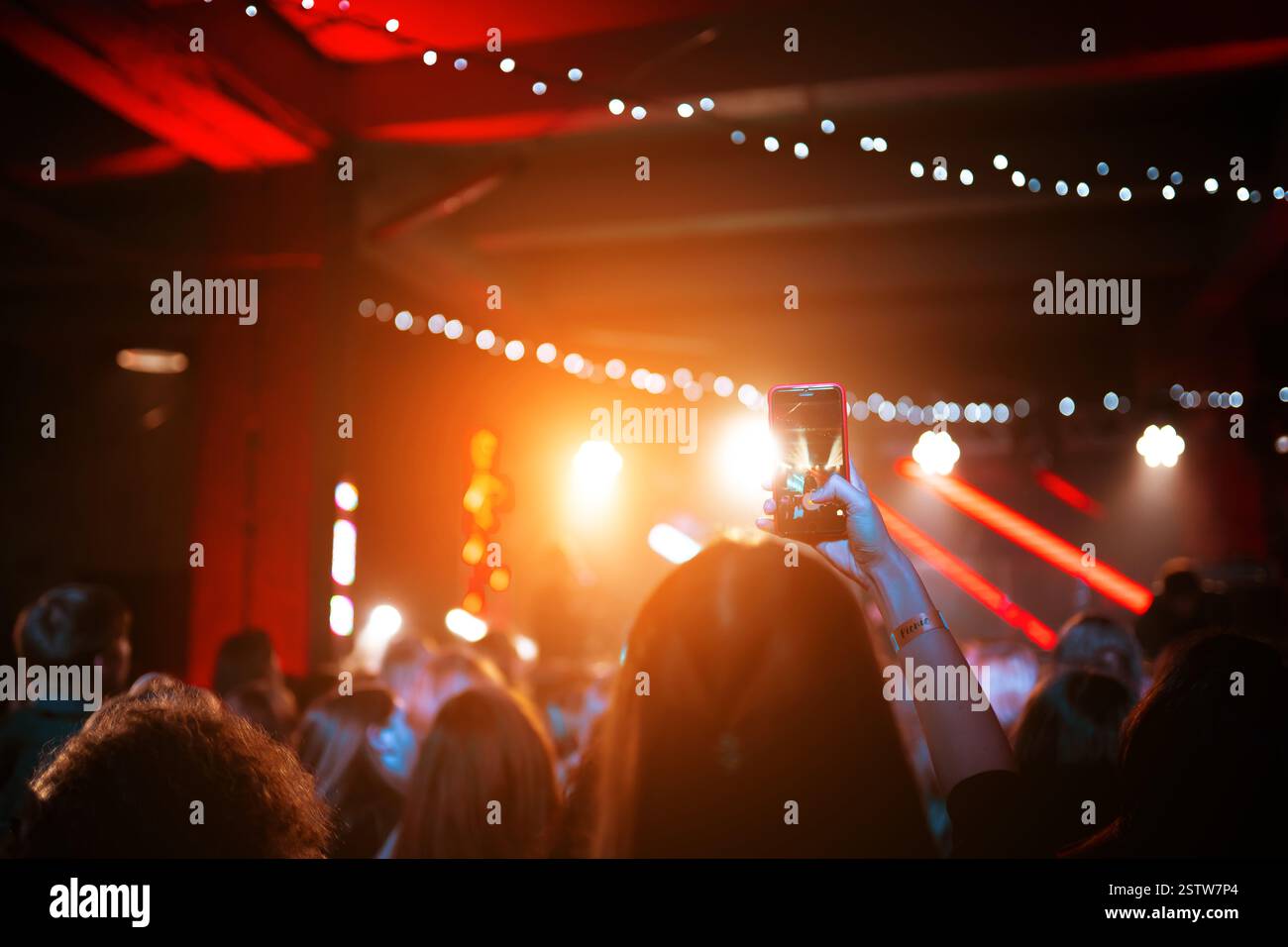 Photo of many people enjoying rock concert in nightclub Stock Photo - Alamy