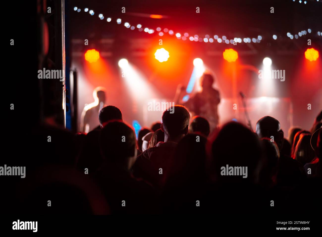 Photo of many people enjoying rock concert in nightclub Stock Photo - Alamy