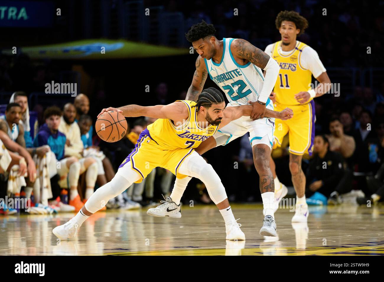 Los Angeles Lakers guard Gabe Vincent, left, dribbles under pressure ...