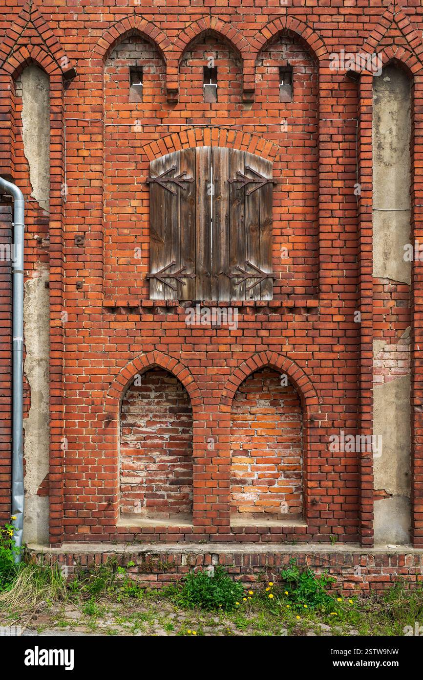 Old brick wall with windows and a door in the Gothic style Stock Photo - Alamy
