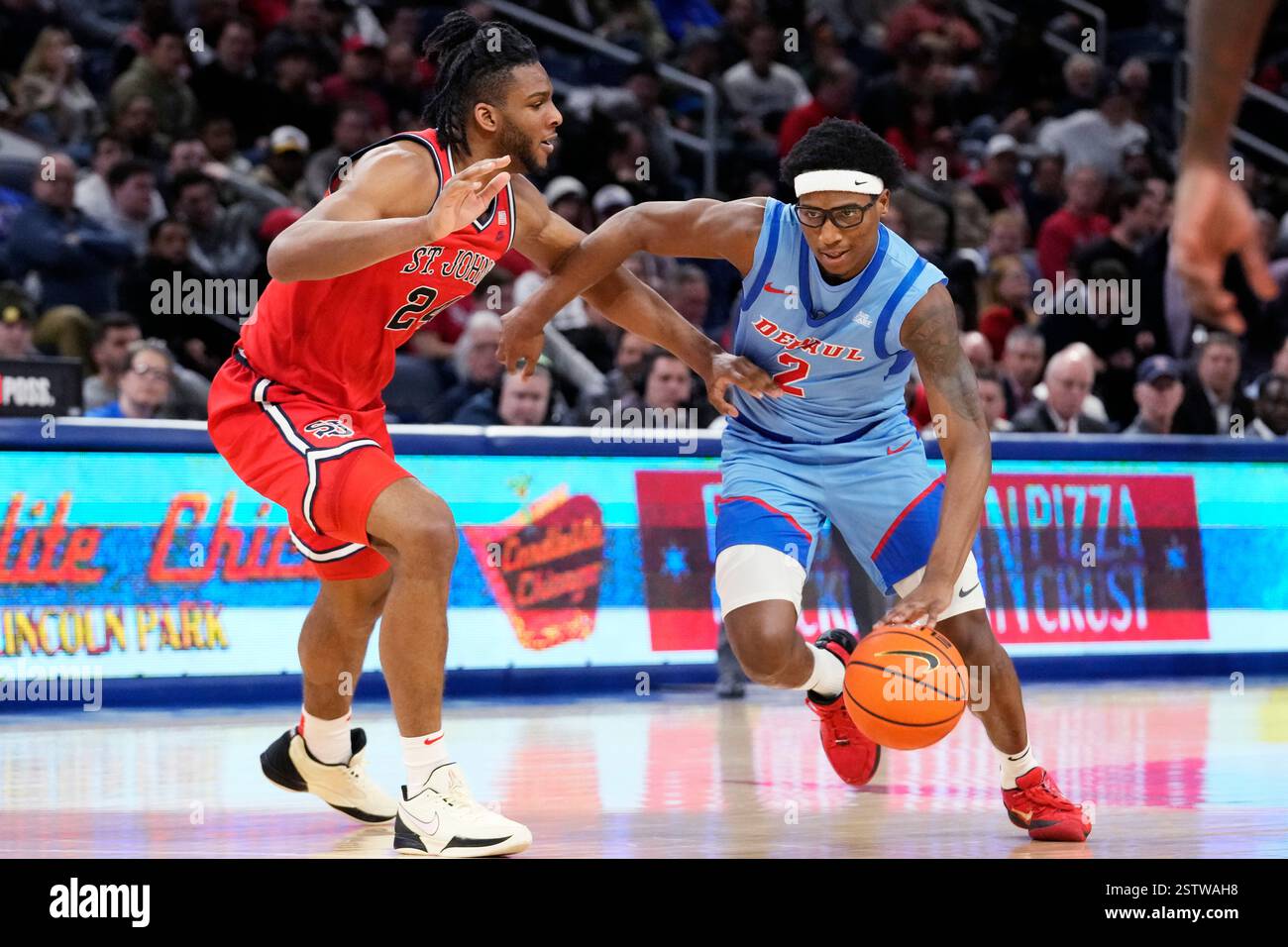 DePaul guard Layden Blocker, right, drives as St. John's forward Zuby ...