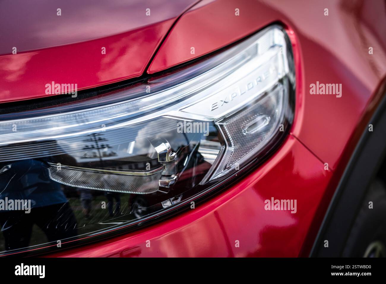 The headlight of mid-size crossover SUV Ford Explorer, close-up. The ...