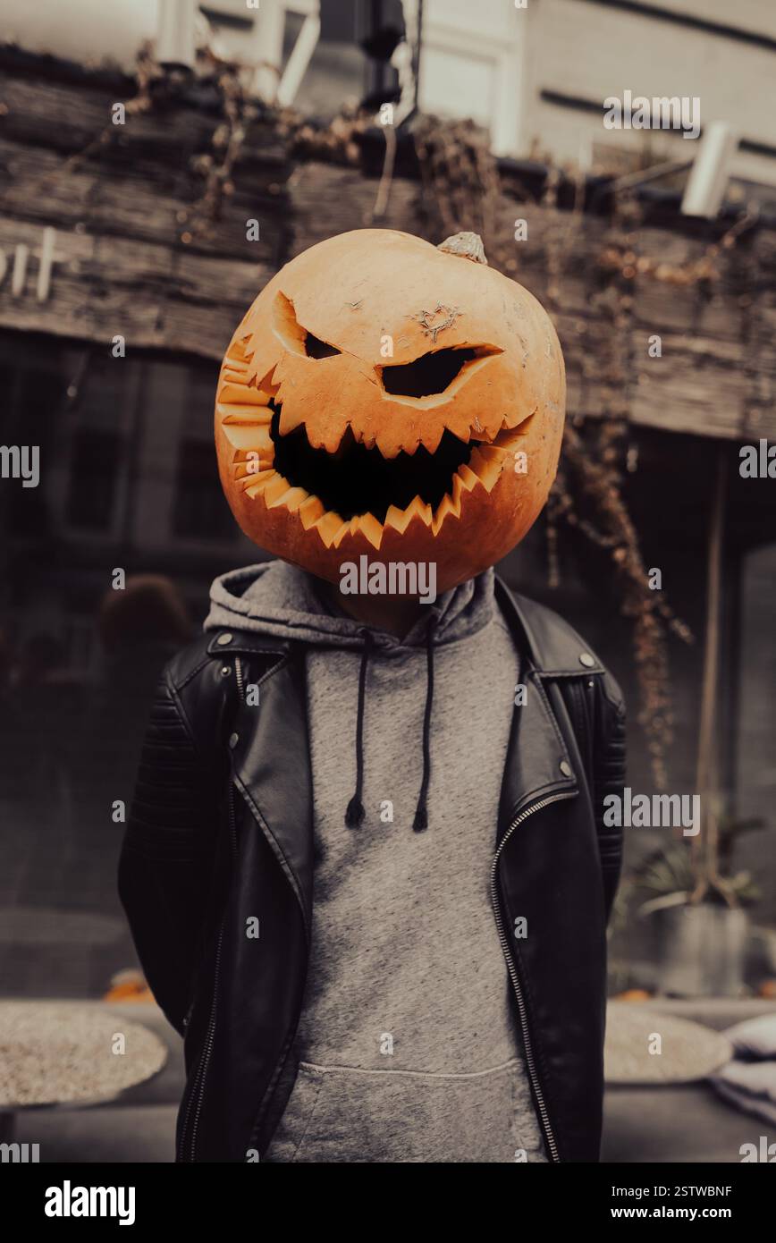 Guy with a pumpkin head poses for the camera Stock Photo - Alamy