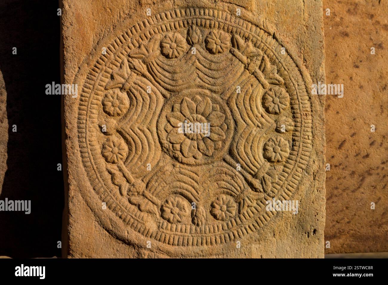A carved medallion, a round decorative carving with floral motifs on ...