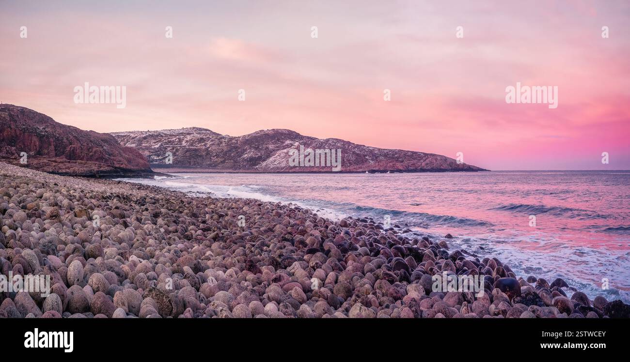 Magical magenta sunset. Wide panorama. Pebbles on the seashore. The ...