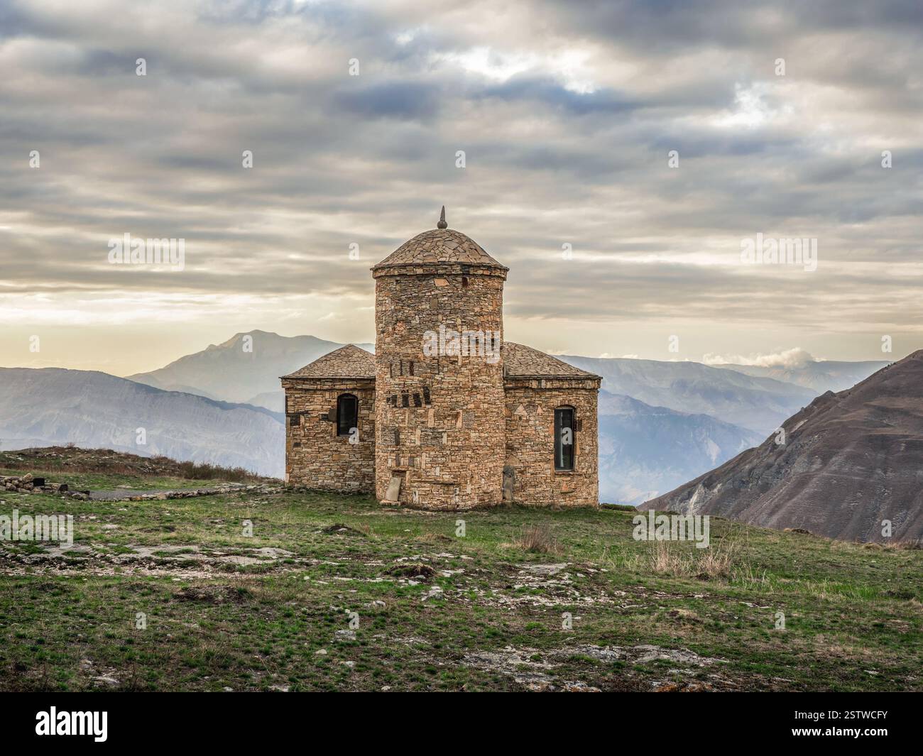 Stone mosque on the background of the dramatic sky. The evening light ...