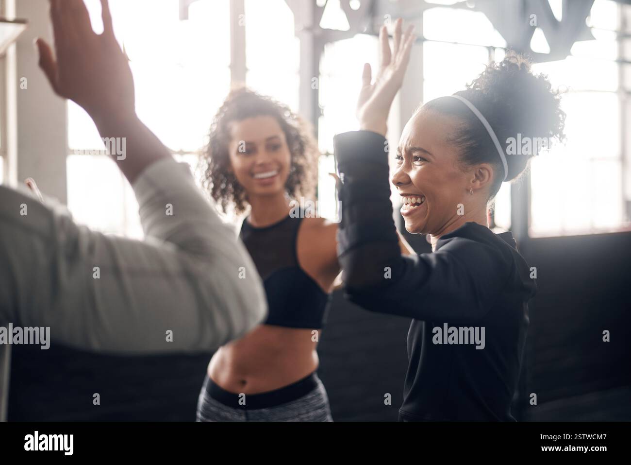 High five, happy and women in gym for fitness, training and workout ...