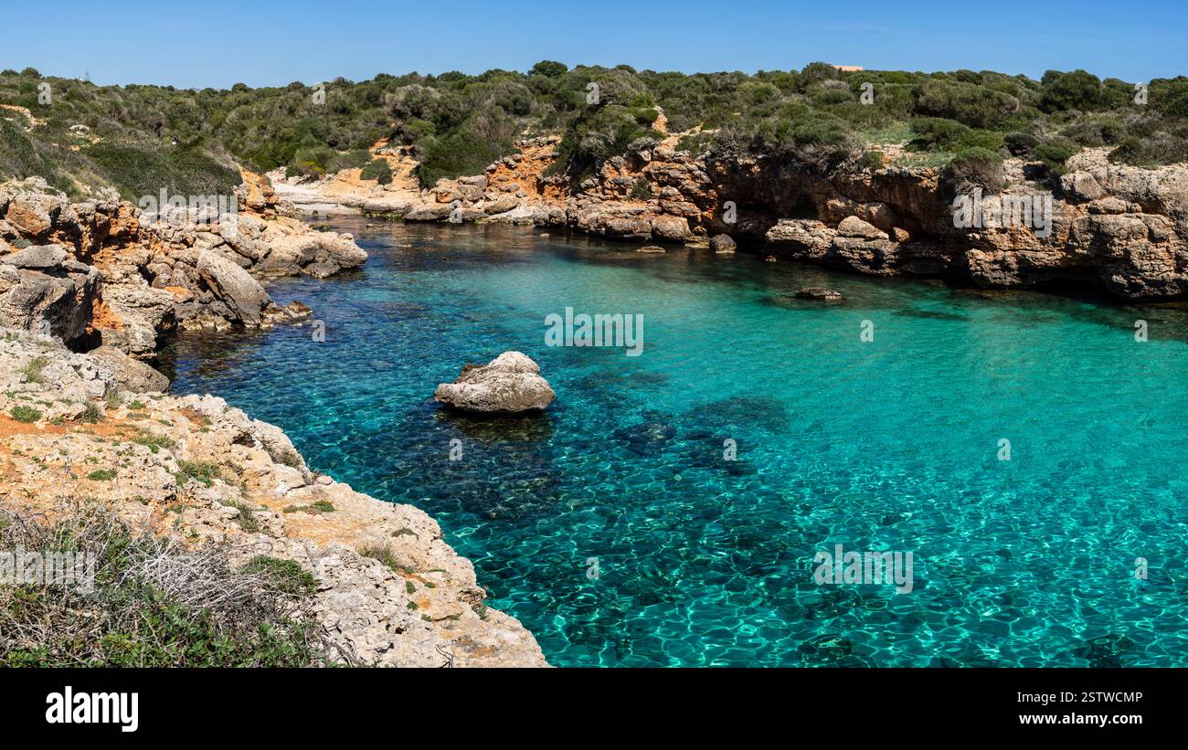 Turquoise waters in Cala Petita Stock Photo - Alamy
