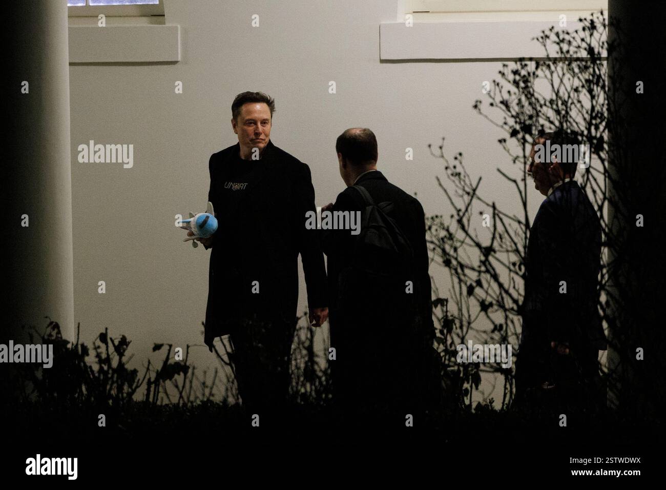Elon Musk is seen with an Air Force One plush toy as he arrives at the ...