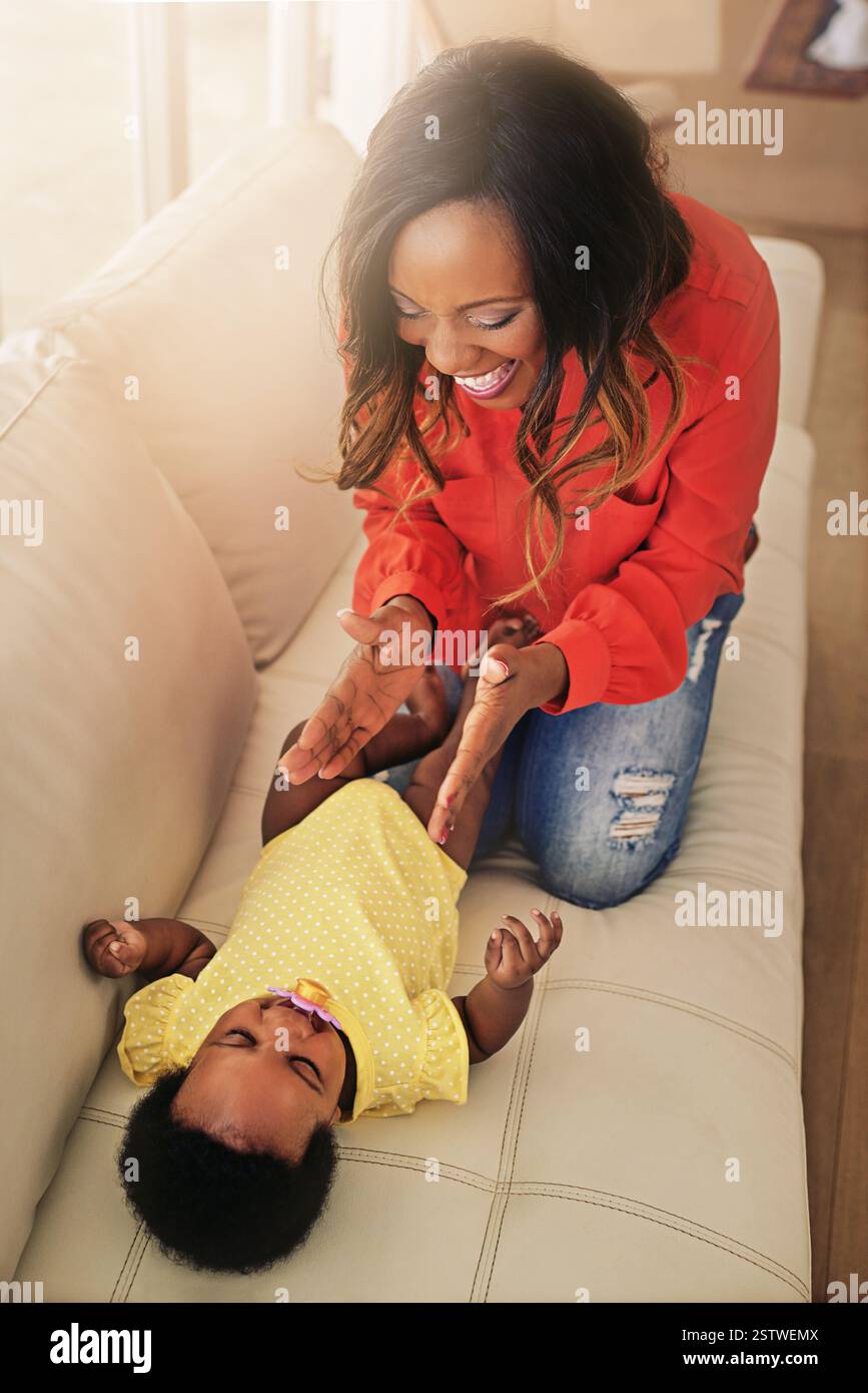 Playing, mom and baby clapping hands in home for bonding activity ...