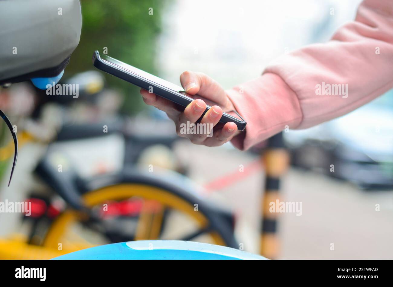People use smart phone to scan the QR code on a shared bike to unlock it Stock Photo - Alamy