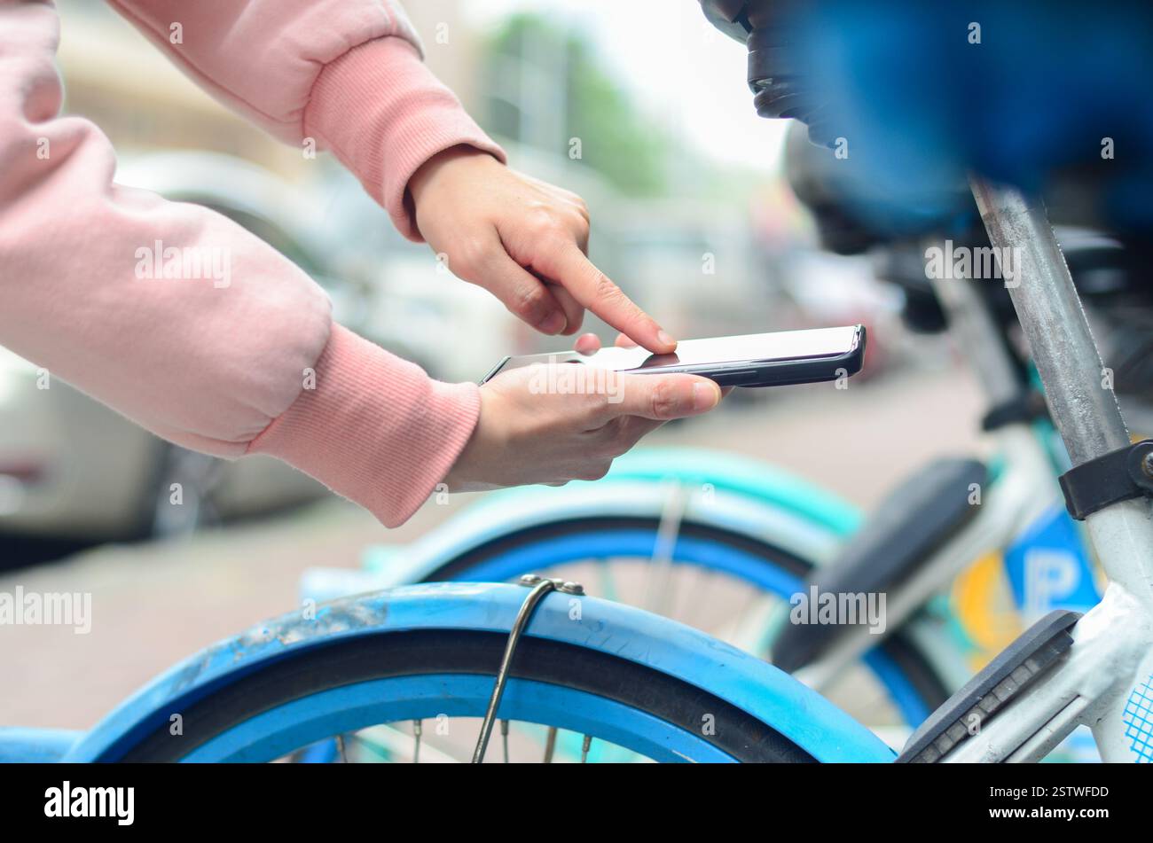 People use smart phone to scan the QR code on a shared bike to unlock it Stock Photo - Alamy