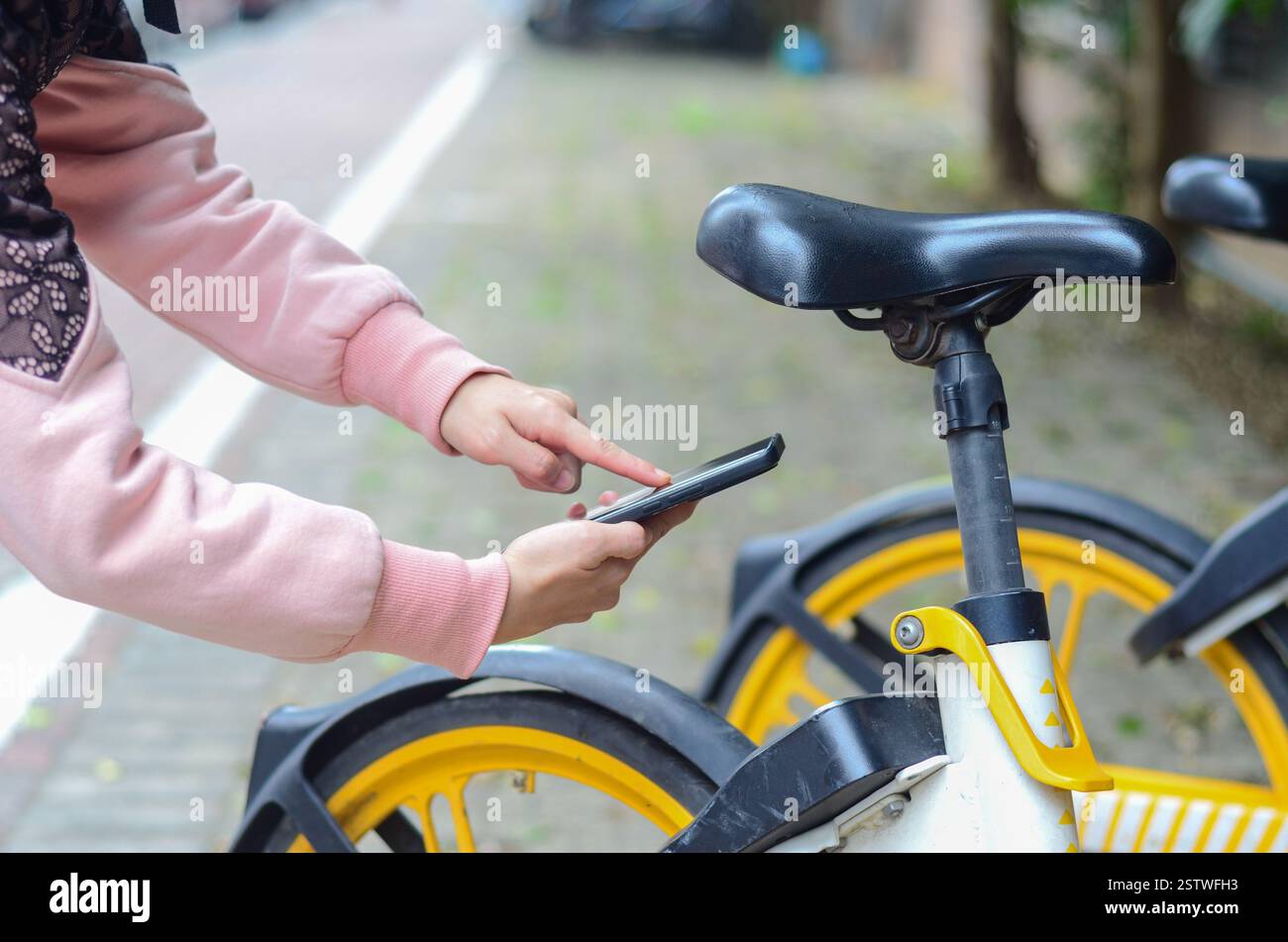 People use smart phone to scan the QR code on a shared bike to unlock it Stock Photo - Alamy