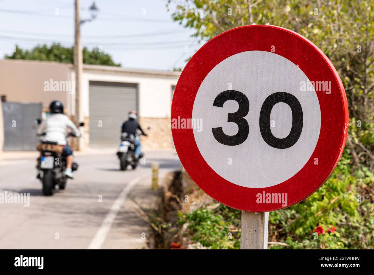 Traffic sign limiting speed to 30 kilometers per hour Stock Photo - Alamy