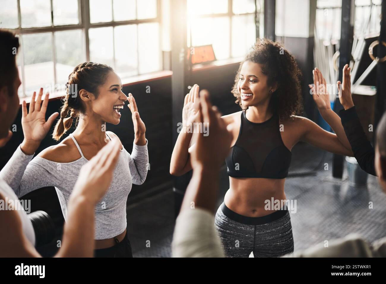 High five, happy and friends in gym for fitness, training and workout ...