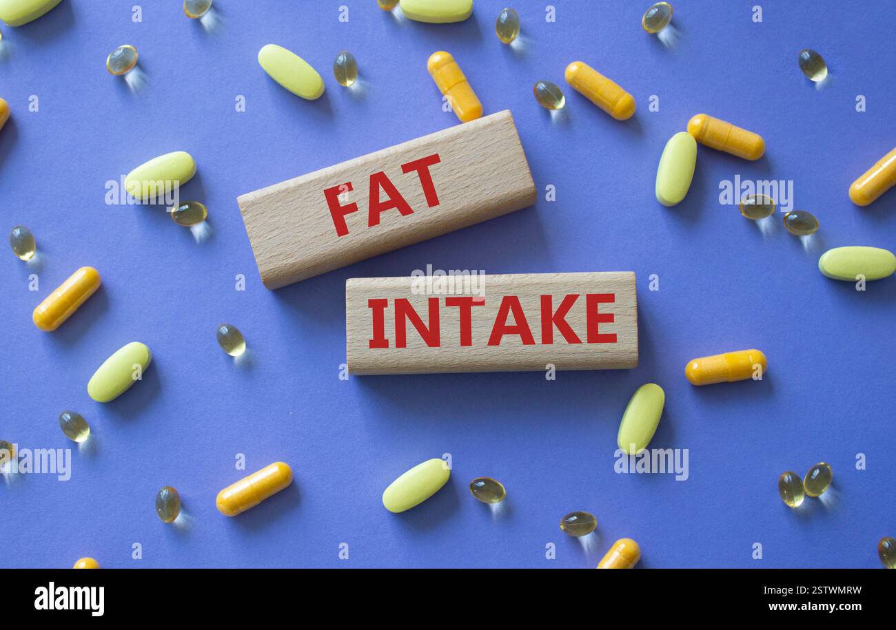 Fat Intake symbol. Concept word Fat Intake on wooden blocks. Beautiful ...