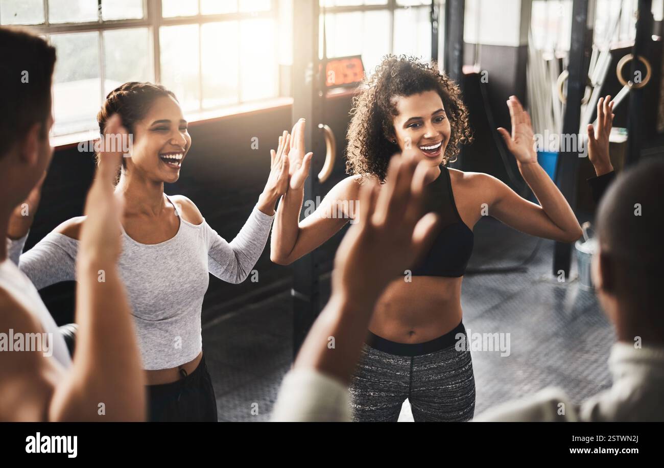 High five, happy and friends in gym for fitness, training and workout ...