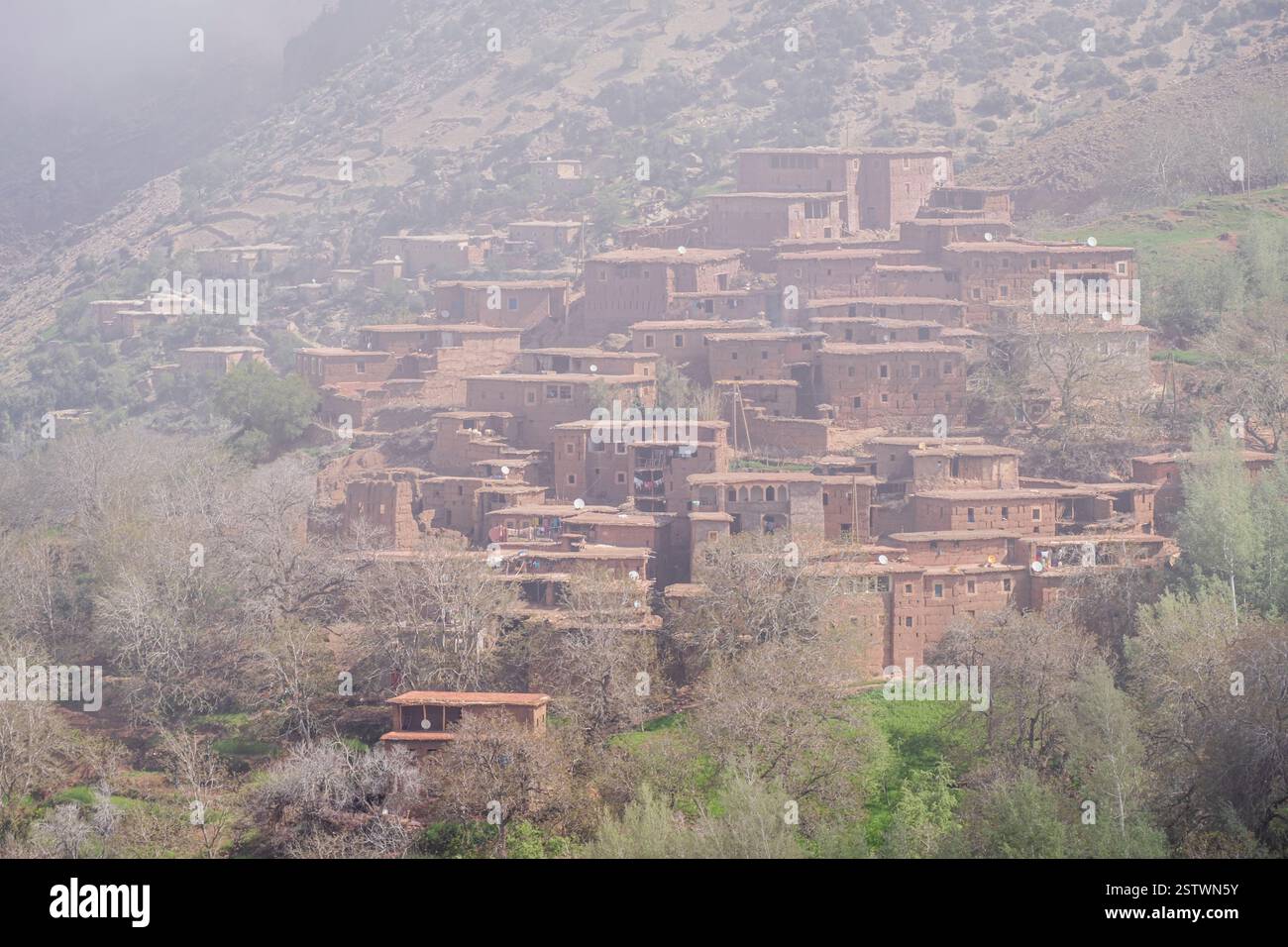 typical adobe houses in the fog, Ait Blal, Atlas mountain range ...