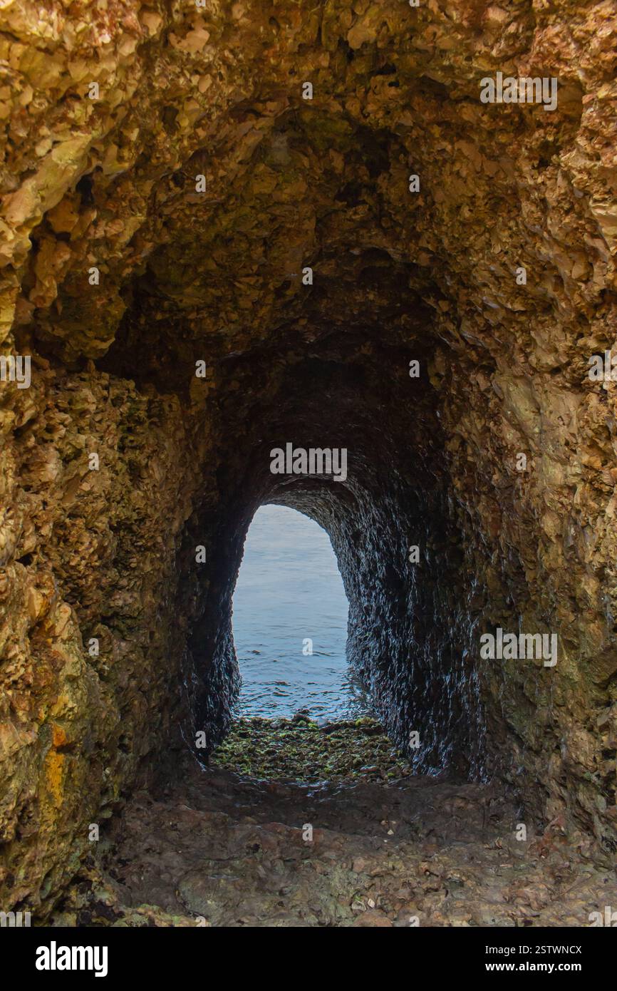 Outdoor stairs to natural cave in rocks. Stone descent to Indian Ocean ...