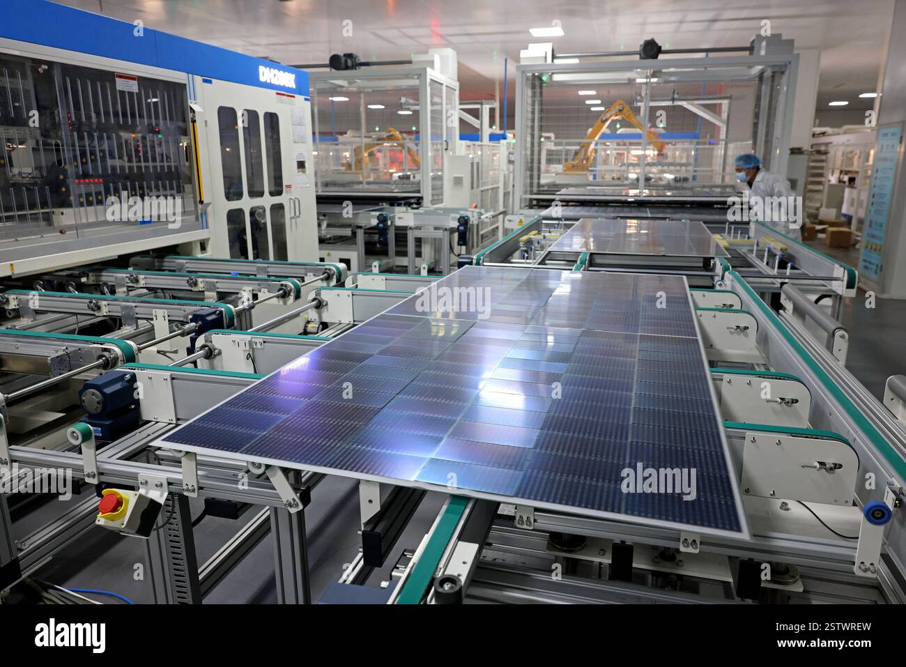 A worker produces photovoltaic modules in an intelligent workshop at a ...