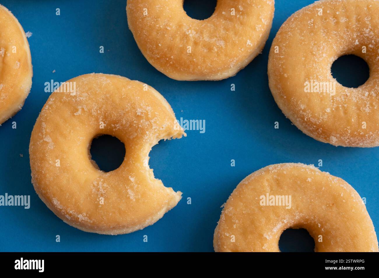 Bitten donut on blue hi-res stock photography and images - Alamy