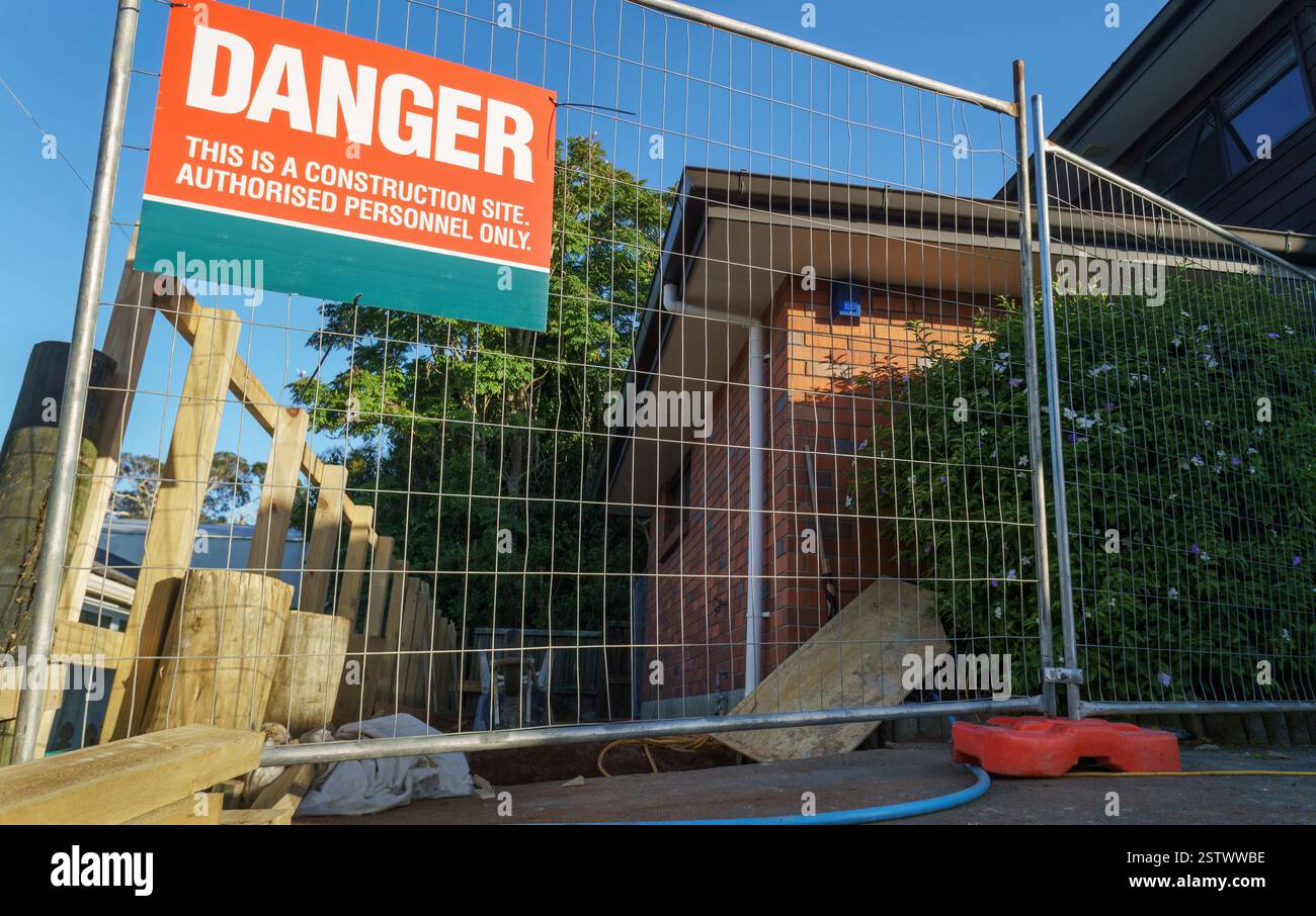 Danger sign on metal protection fence. Construction site for ...