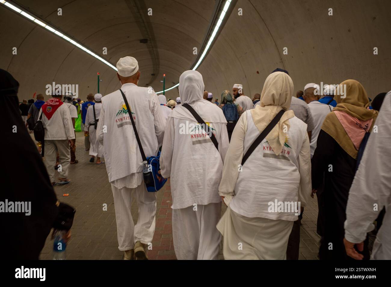 Mina, Saudi Arabia - June 18, 2024: Hajj pilgrim from Kyrgyzstan walking towards the Jamarat ...