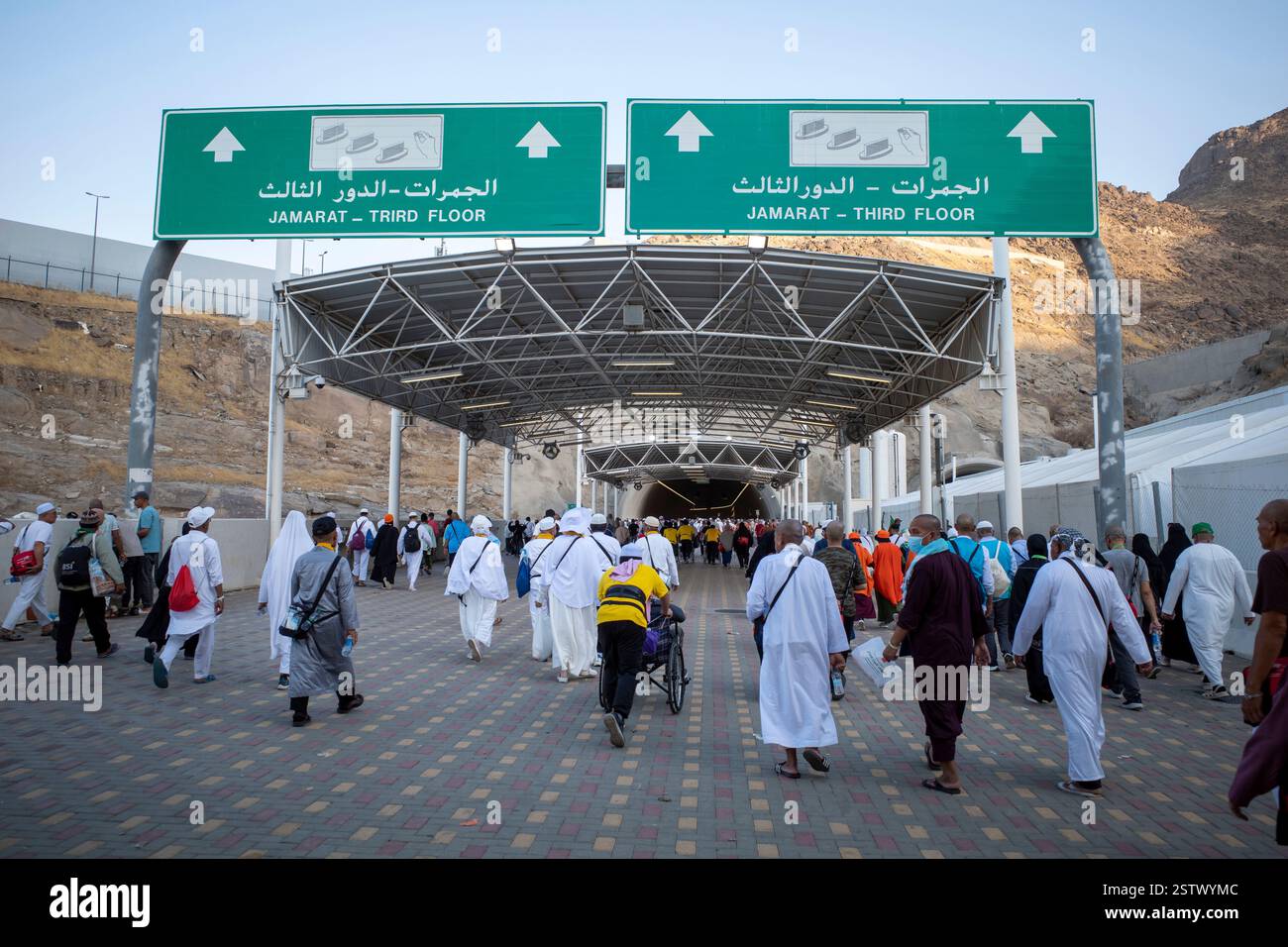 Mina, Saudi Arabia - June 18, 2024: Hajj pilgrims walking towards the Jamarat stoning ritual in ...