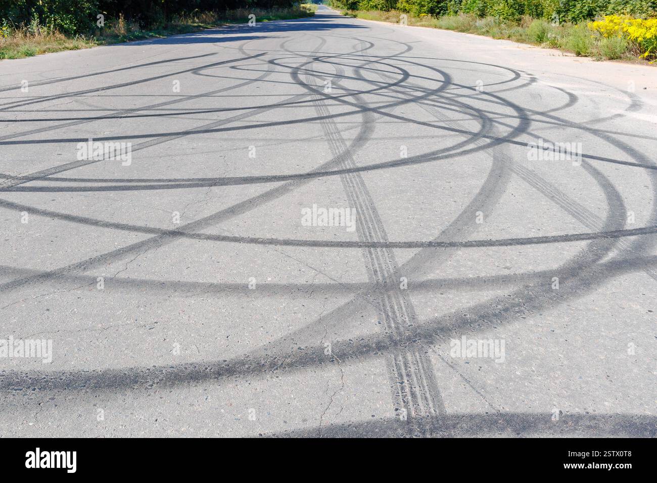 Skid marks on the road surface. Circular tire tracks left by drivers ...