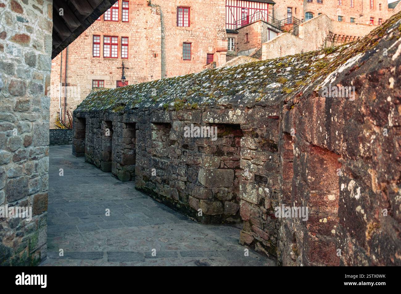 Mont Saint-Michel, France - January 26, 2016: A narrow stone passageway ...