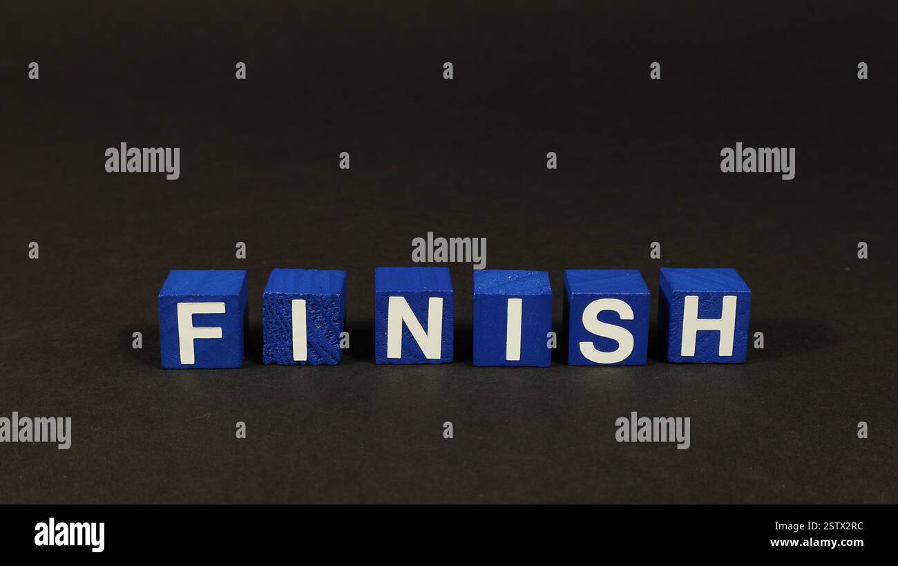 FINISH writing on black background to write text Stock Photo - Alamy