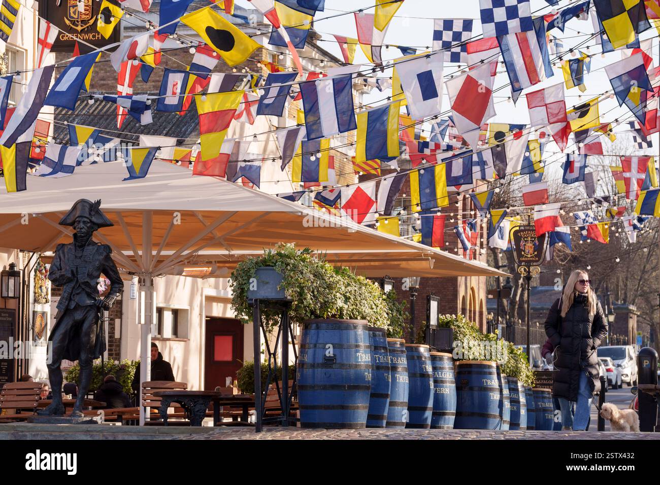 Naval nautical flags hang above the statue of Admiral Lord Nelson at ...