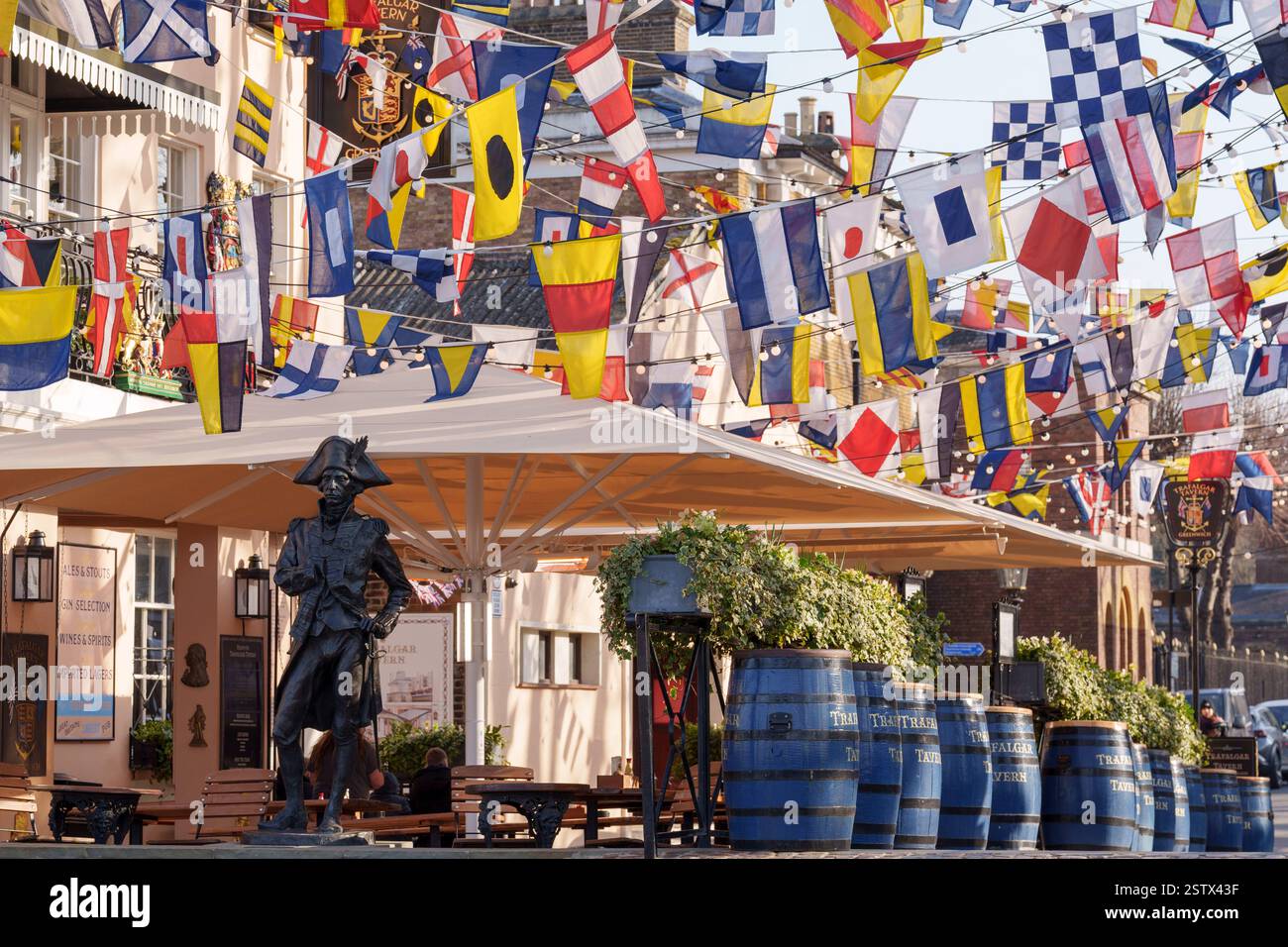 Naval nautical flags hang above the statue of Admiral Lord Nelson at ...