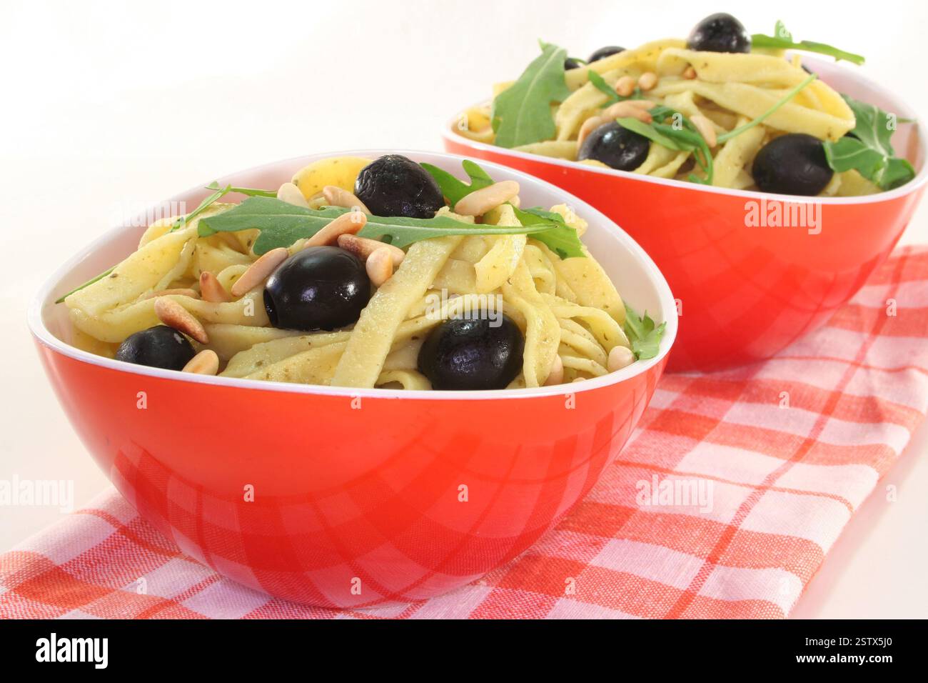Ribbon noodles with rocket salad Stock Photo - Alamy