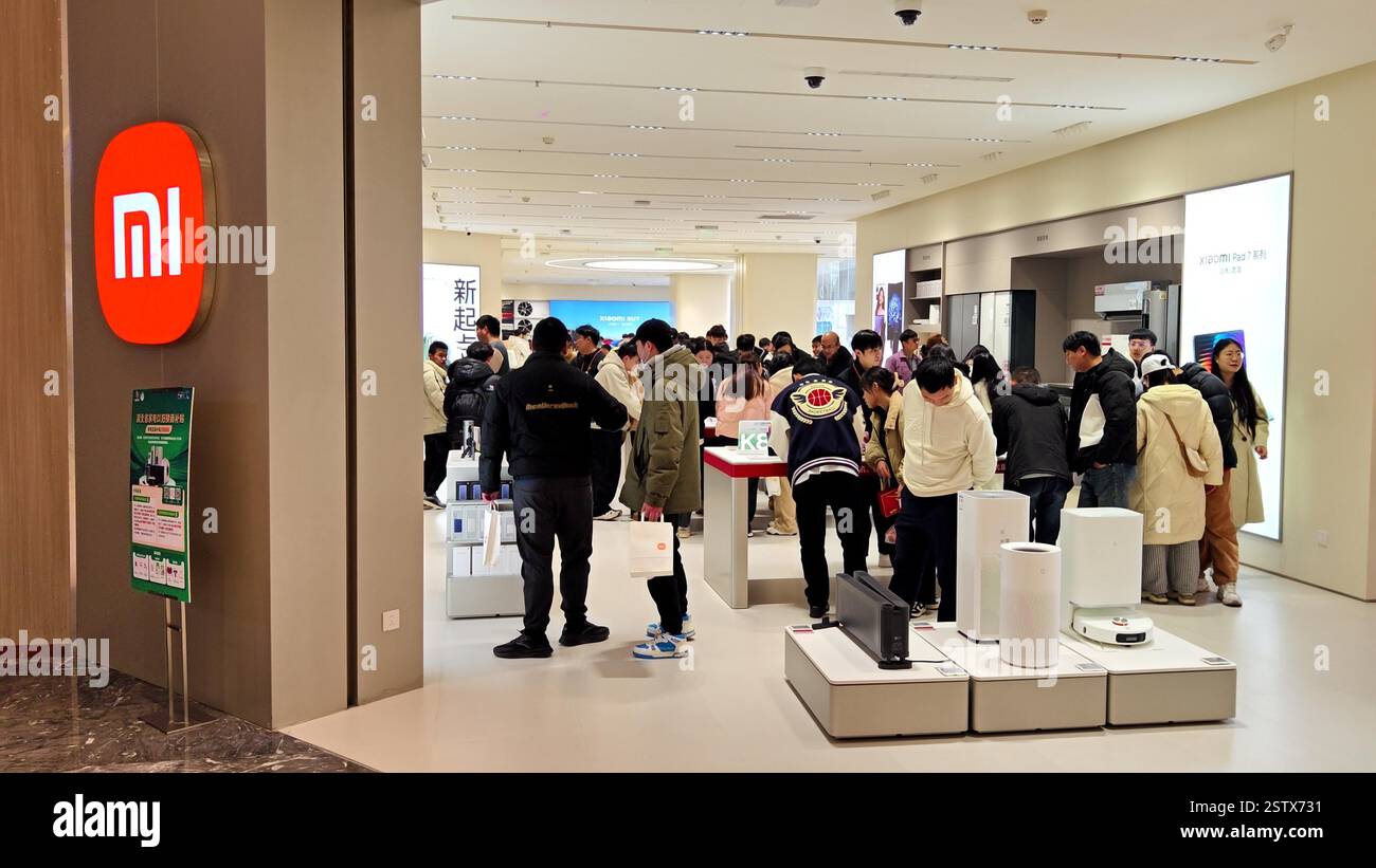Customers select electronic products in a Xiaomi store in Wuhan City, central China's Hubei ...