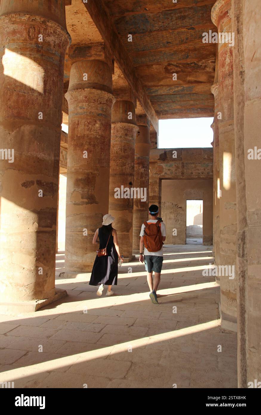 A couple walking inside the Festival Hall of Thutmose III in Karnak ...