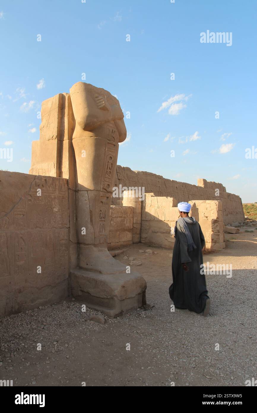 An Egyptian and headless colossal statue at the Easten Edge of Karnak ...