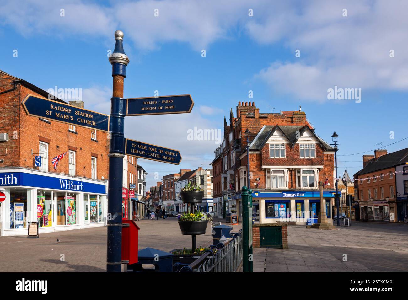 Direction sign and shops on a quiet Sunday March afternoon in the ...