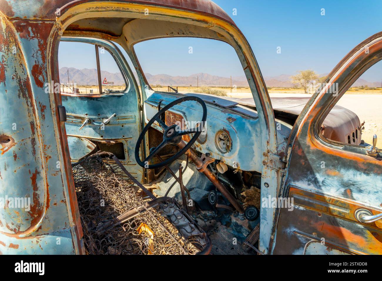 Close up of the interior of an old rusty car wreck in the desert in SOlitaire, Namibia, Africa ...