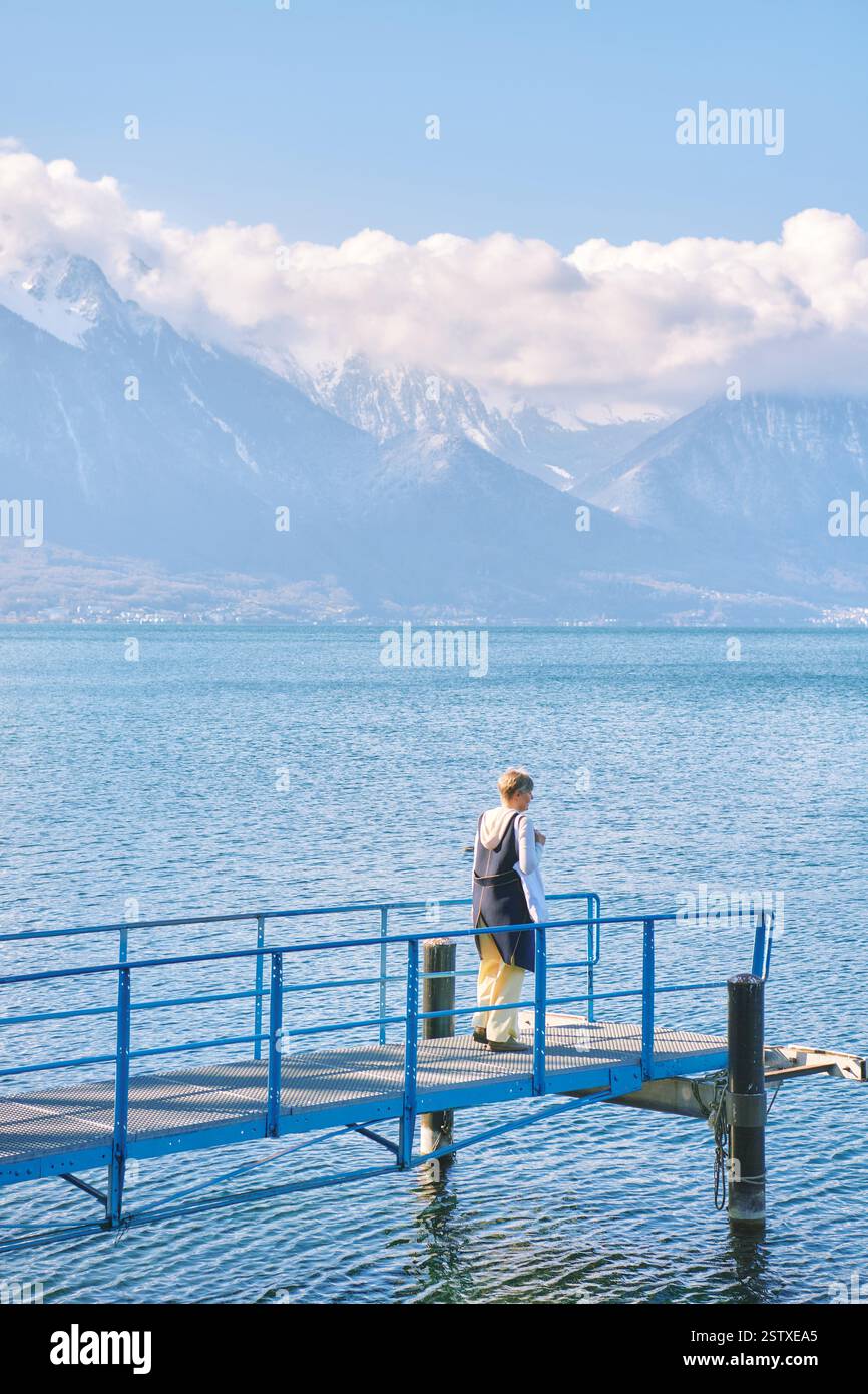 Nature background of lake Geneva and swiss Alps, woman admiring winter landscape, image taken in ...