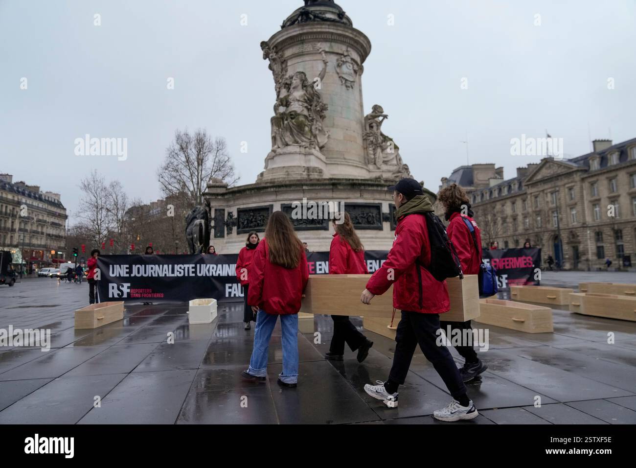 Members of RSF (Reporters Without Borders) carry a mock coffin during a ...