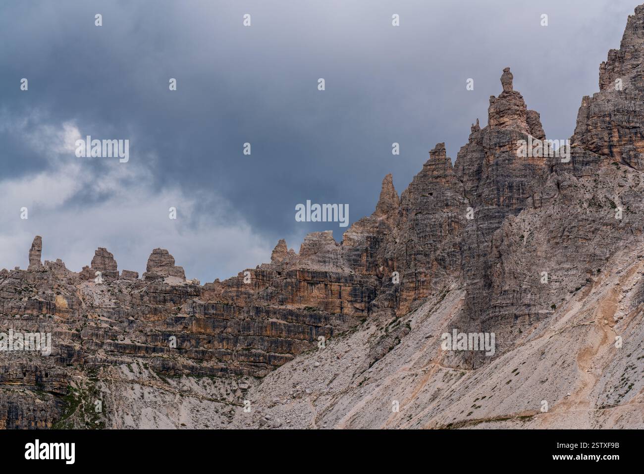 Sharp and towering rock peaks Dolomites rise dramatically against sky ...