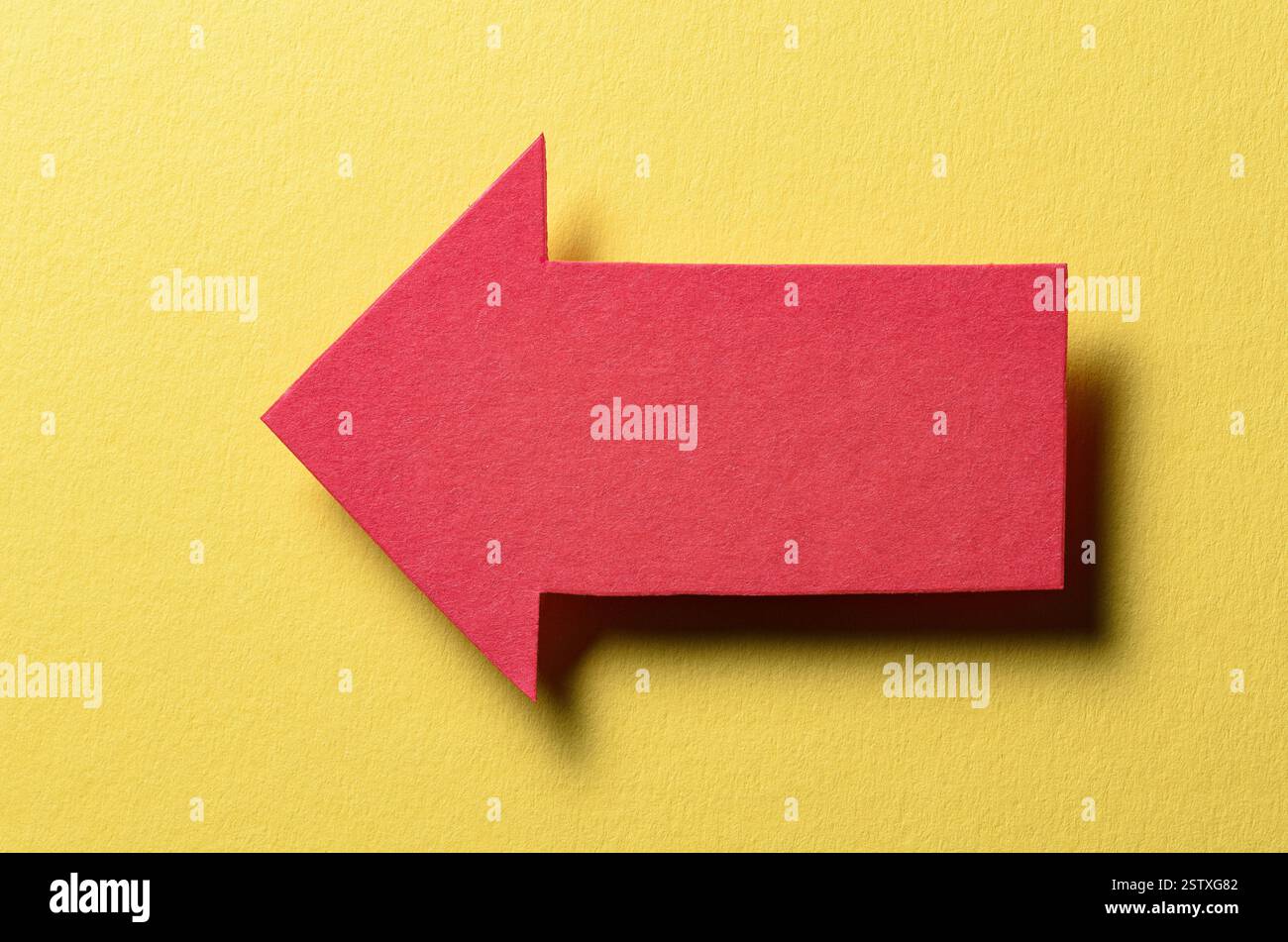 Red cut out blank paper cardboard arrow direction sign with copy space ...