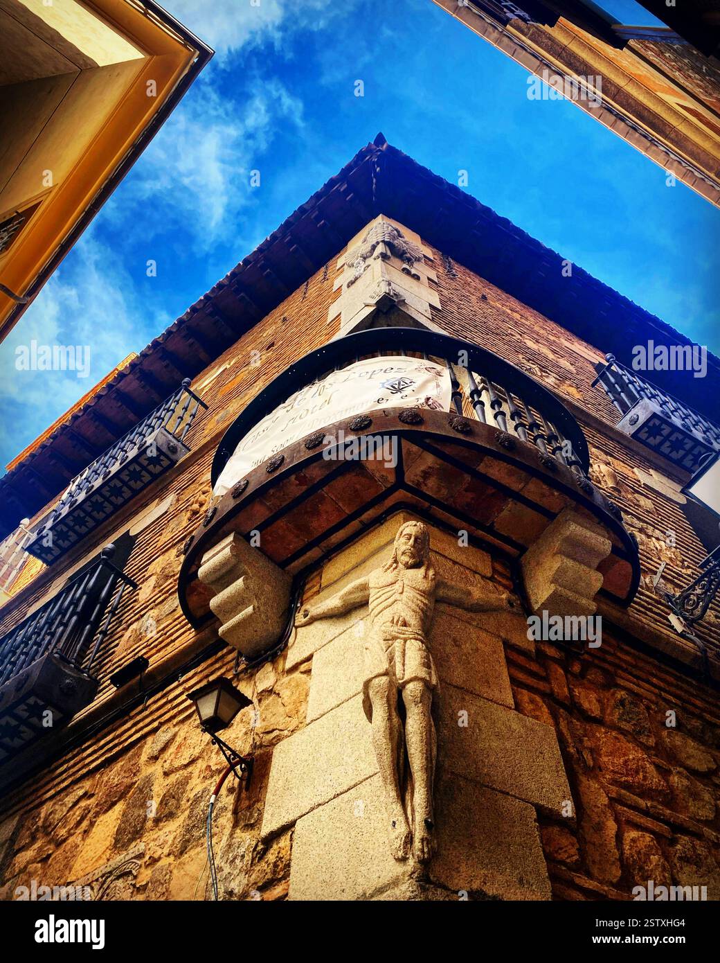 A sculpture of Jesus Christ crucified decorates a corner in a street of ...